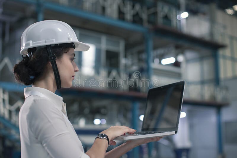 Side Profile of a Female Technical Engineer Working on a Laptop in the ...