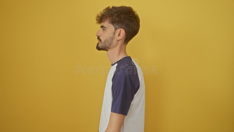 Side Profile of a Young Hispanic Man with a Beard Standing Against a ...