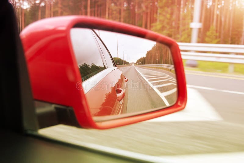 Side Rearview Mirror of a Red Car, Roadside and Highway Reflection ...