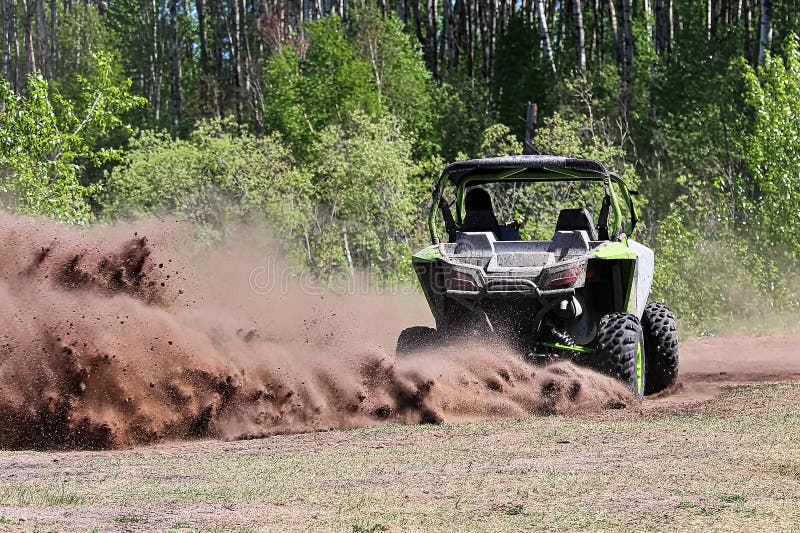 A Side-by-side Ripping Up Dirt As it Turns a Corner Stock Photo - Image ...
