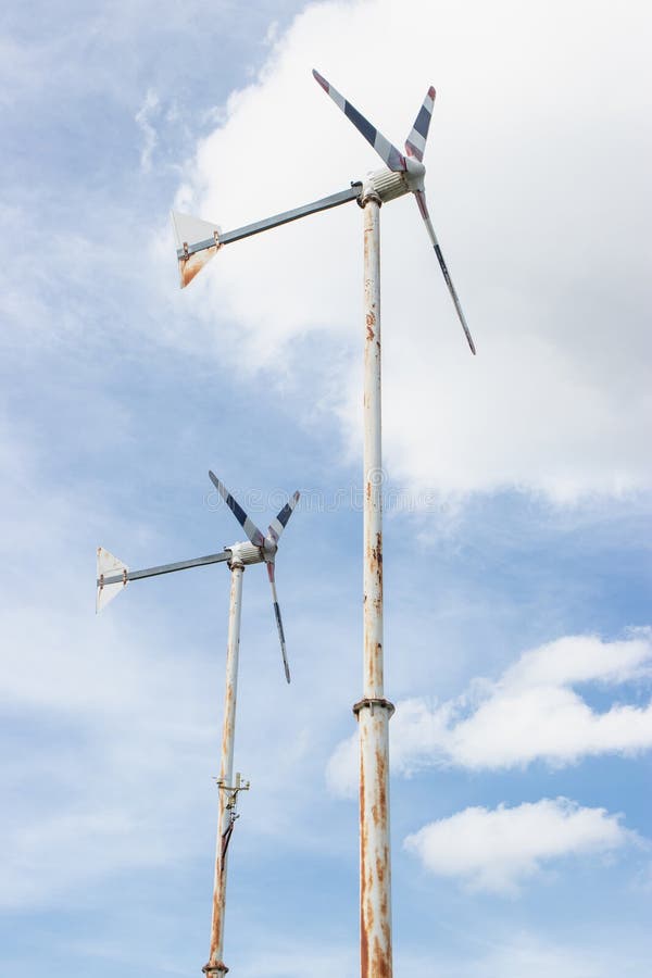 The Side of a Rusty Metal Stand of Windwheels is Spinning in the Blue ...