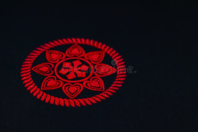 Side Shot of Beautiful Red Rangoli Design on Black Background with Copy ...