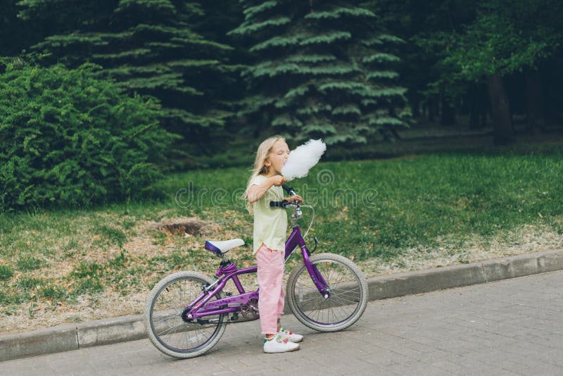 Side View of Adorable Kid with Bicycle Eating Cotton Candy Stock Image ...