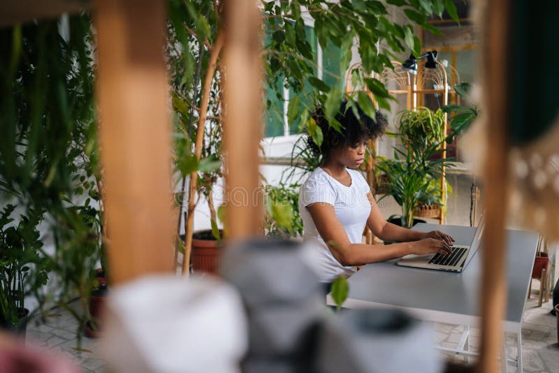 Side View of African-American Feamle Student Focused Looking at ...