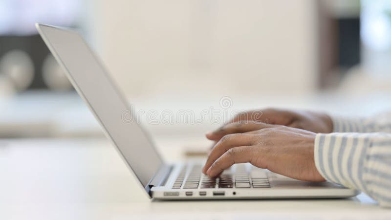 Side View of African Man Typing on Laptop Stock Image - Image of ...