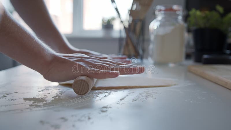 Side View, Anonymous Person Using a Rolling Pin To Roll Out Dough at ...