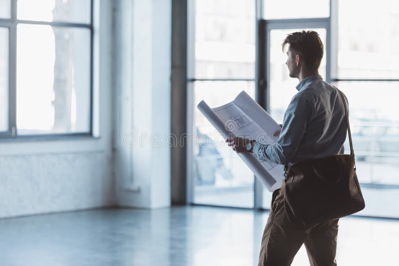 Side View of Architect with Blueprint in Hands Standing Stock Photo ...