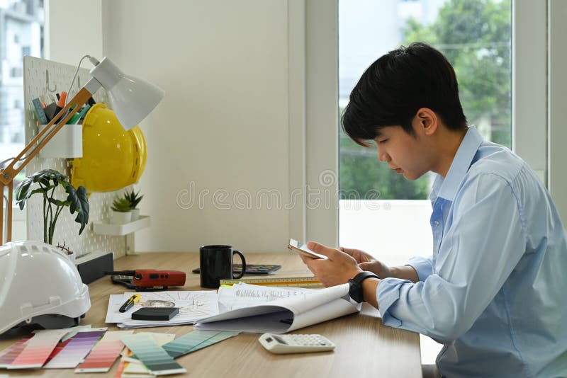 Side View of Architect Man Working on Design of a Construction Plan and ...