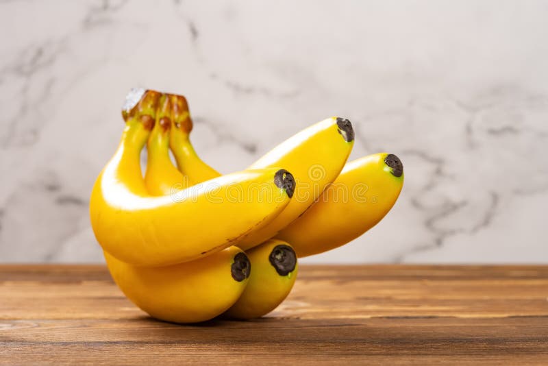 Artificial Bananas on a Wood Table Stock Photo - Image of artificial ...