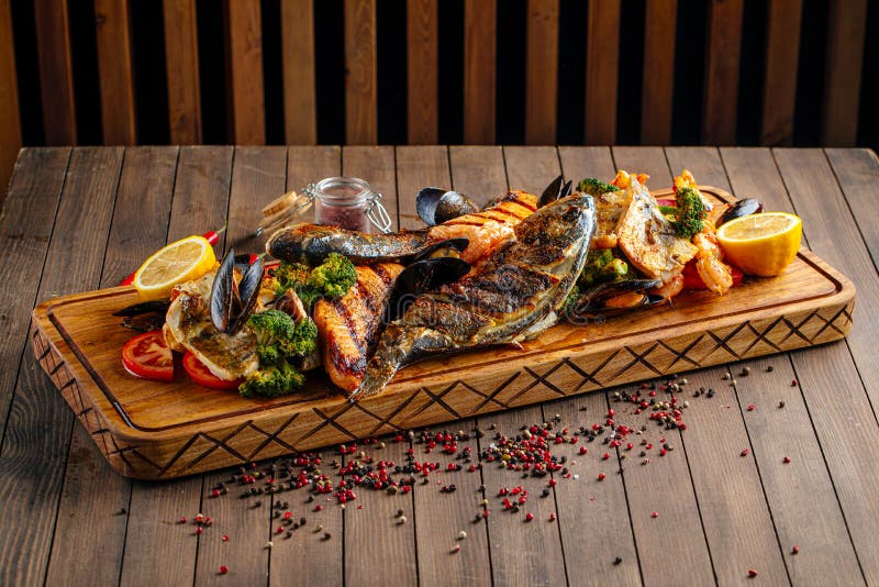 Assorted Grilled Fish Set on Wooden Serving Board Stock Image - Image ...