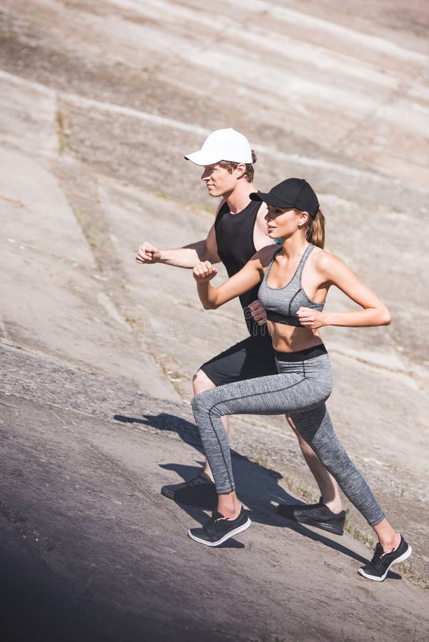 Couple jogging on slabs stock image. Image of sportswoman - 102010497