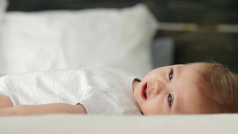 Side View of Baby Lying on the Bed Stock Footage - Video of clothing ...