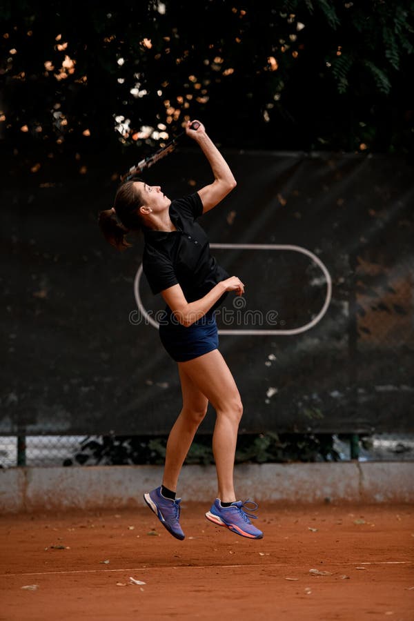 Side View of Beautiful Bouncing Woman Tennis Player with Tennis Racket ...
