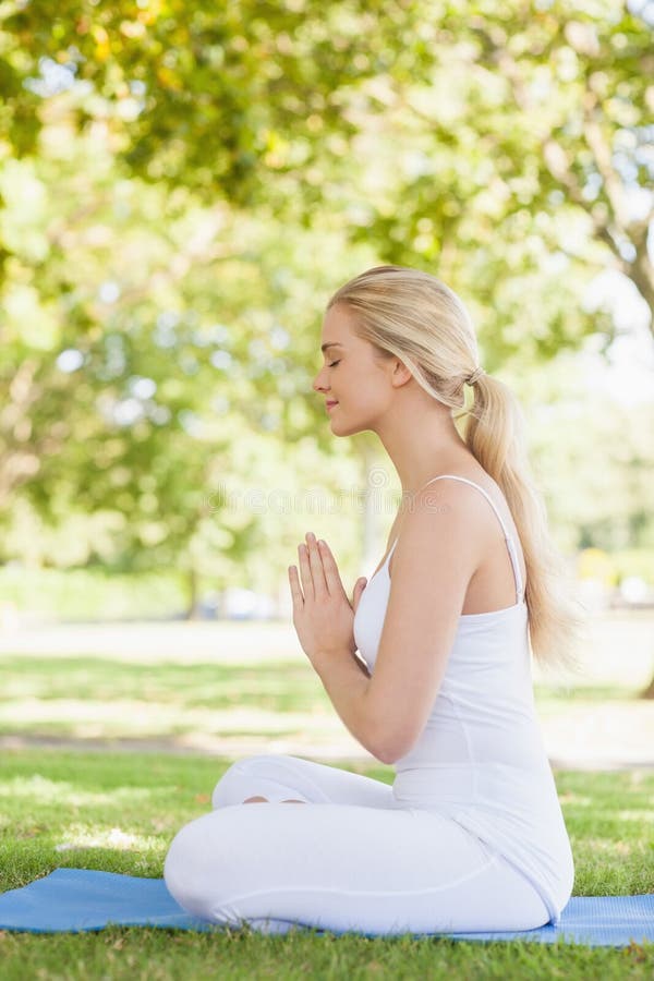 Side View of Beautiful Calm Woman Meditating Sitting on an Exercise Mat ...