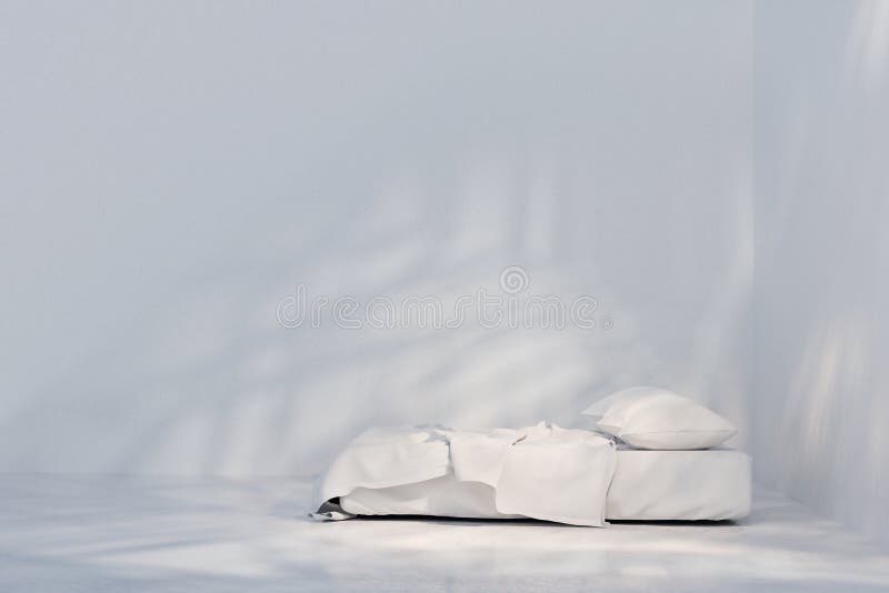 Side View of Bed with White Linen. Light and Shadows on White Wall ...