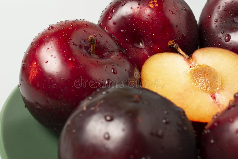 Side View of Big Red Plums on Green Plate Stock Photo - Image of ...