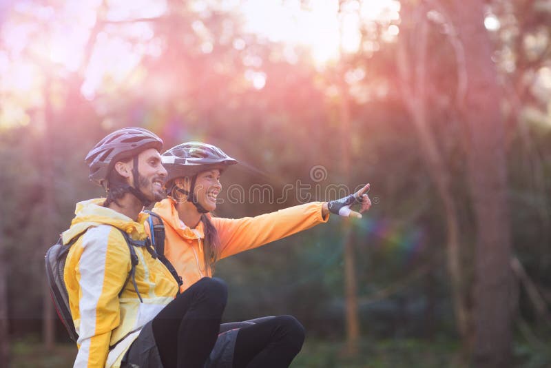Side View of Biker Couple Sitting and Pointing in Distance Stock Image ...