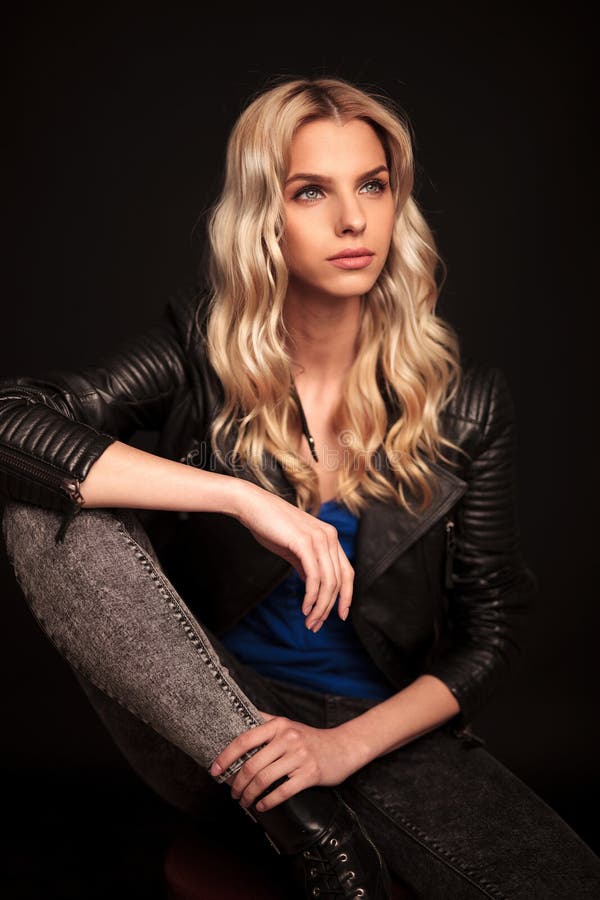 Side View of a Blond Woman in Leather Jacket Sitting Stock Image ...