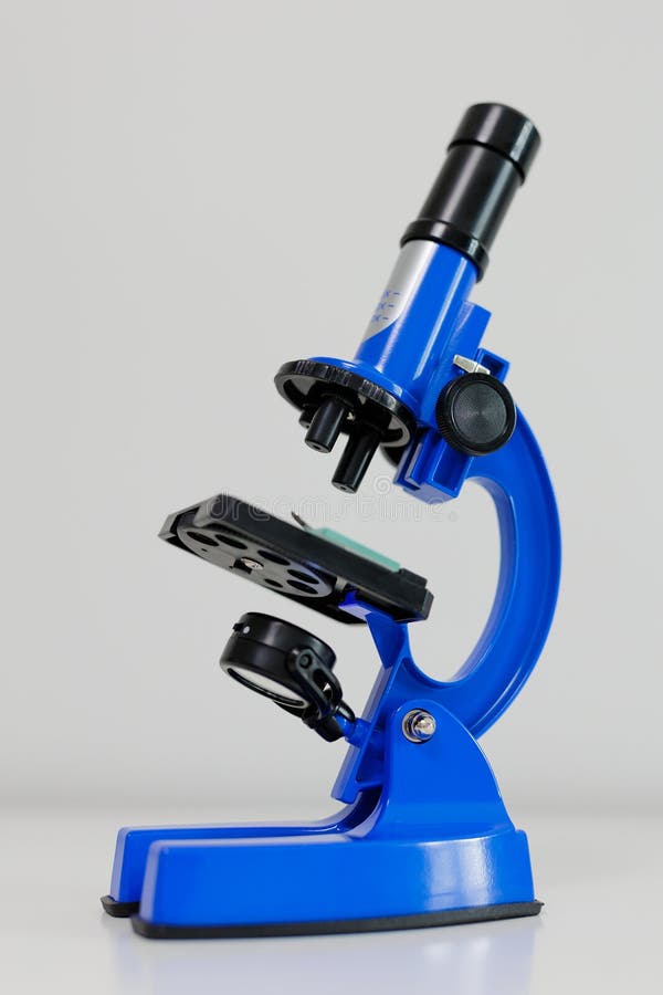 Side View of Blue Microscope on White Table Stock Photo - Image of ...