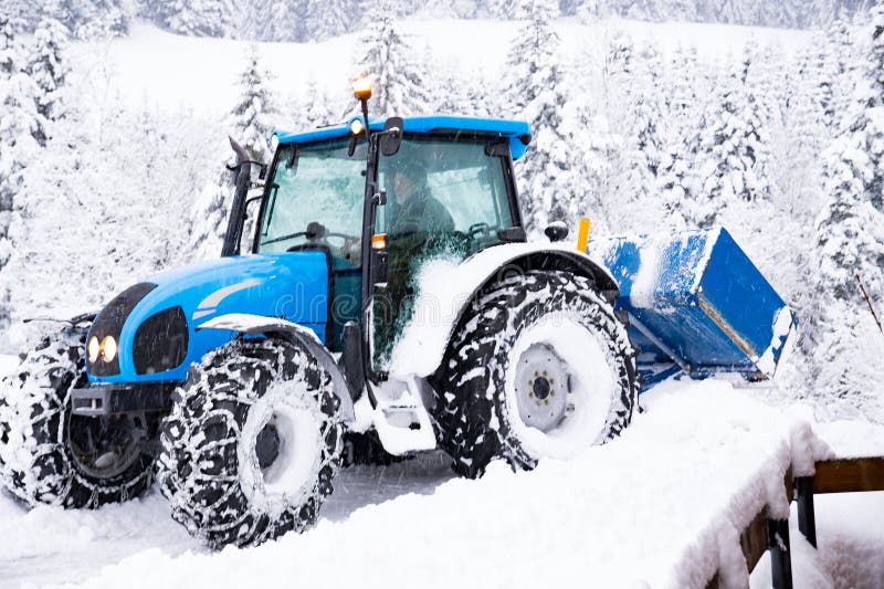Side View of Tractor with Loader and Snow Chains Clearing Snow Stock ...