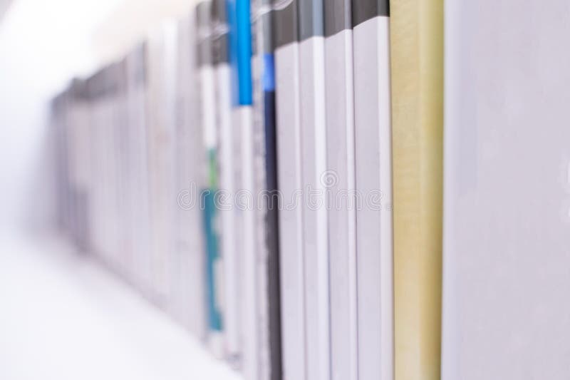 Side View of Books Arranged in a Row on a Bookshelf Stock Photo - Image ...