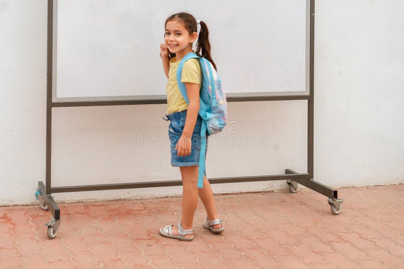 Side View of Brunette Child in School Writing on School Board. Stock ...