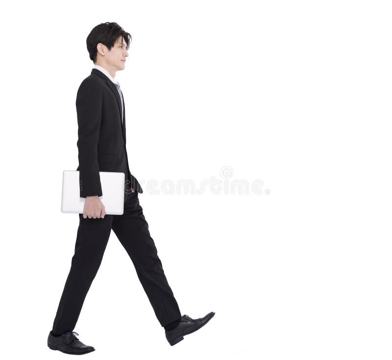 Side View of Business Man Walking and Holding a Laptop Stock Photo ...