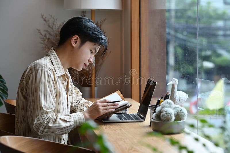 Businessman Sitting in Front of Laptop Computer and Reading Information ...