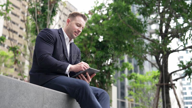 Side View of Manager Sitting while Writing on Tablet and Plan Strategy ...