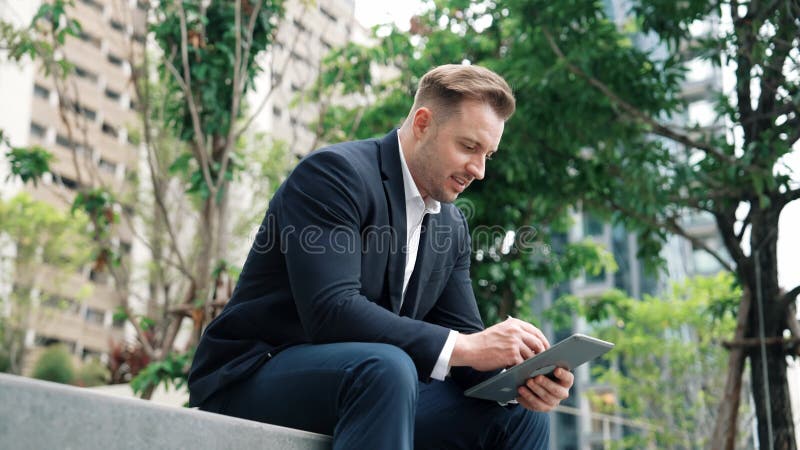 Side View of Manager Sitting while Writing on Tablet and Plan Strategy ...