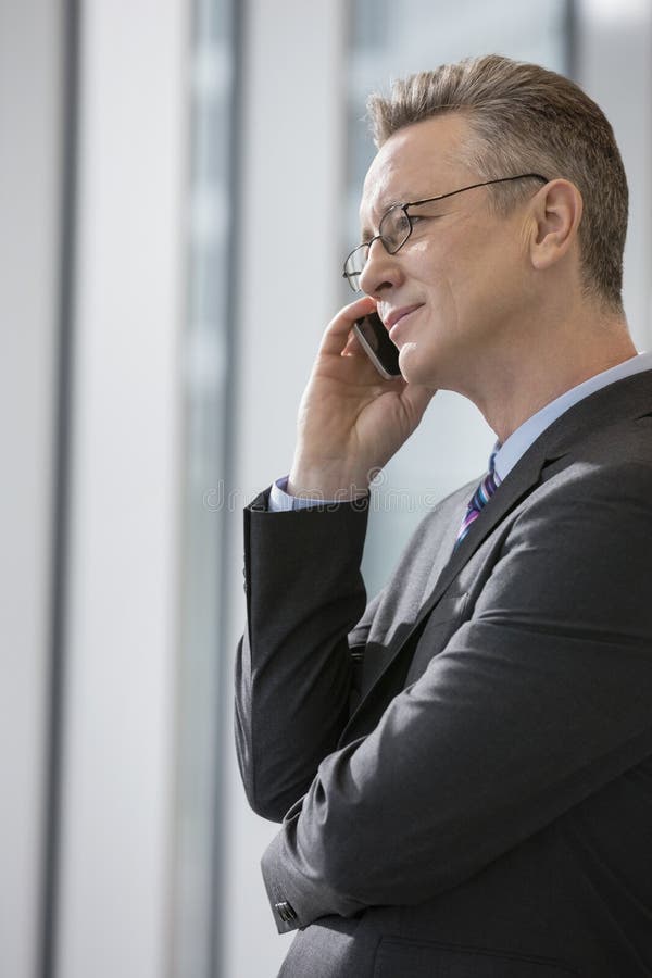 Side View of Businessman Using Cell Phone in Office Stock Image - Image ...