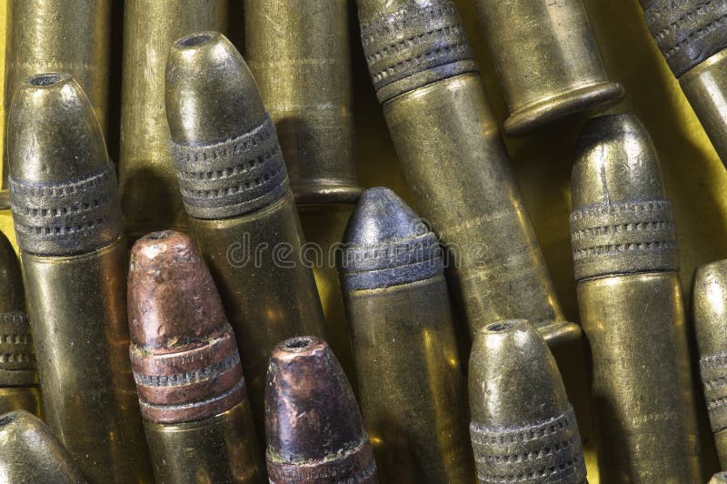 Various Bullets on a Yellow Background Stock Photo - Image of miniature ...