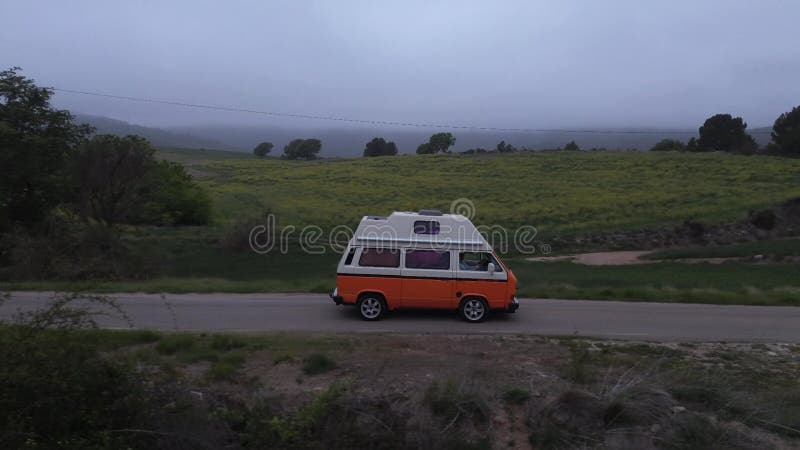 Side View of a Camper Van on a Road between Meadows Stock Video - Video ...