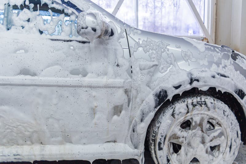 A Side View of Car Covered by Soap Foam while Washing Indoors - Close ...
