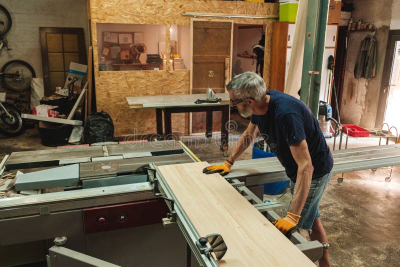 Carpenter Handling Large Pieces of Wood on an Industrial Cutting ...