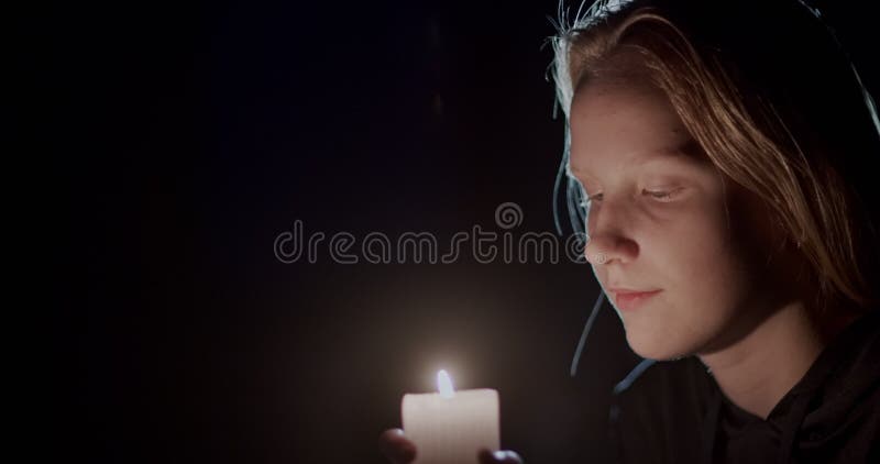Side View: Child Looking at a Candle Burning in the Dark. Stock Footage ...
