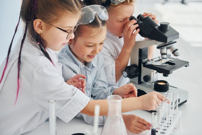 Side View. Children in White Coats Plays a Scientists in Lab by Using ...