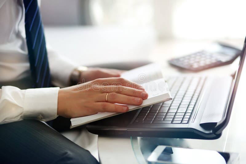 Side View and Close Up of Man`s Hands Using Laptop and Notepad. Working ...