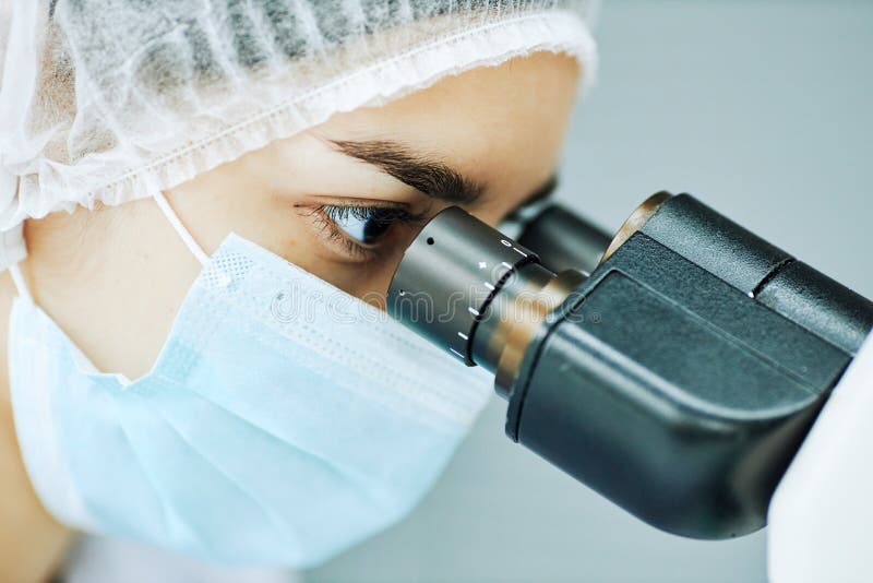 Closeup Young Female Medic Looking in Microscope Doing Research in ...