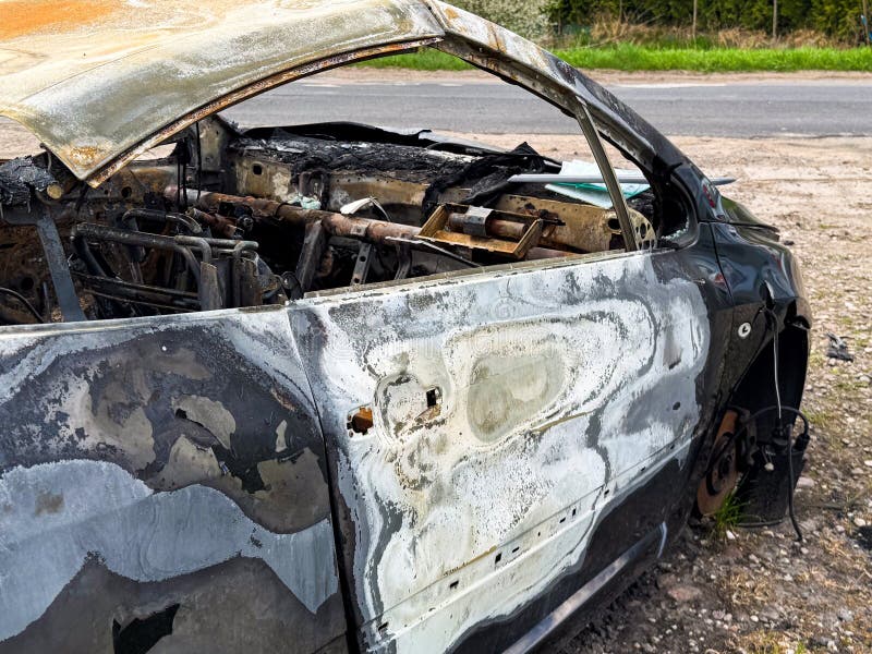 Side View of a Completely Burned Car Showing Warped and Blistered Paint ...
