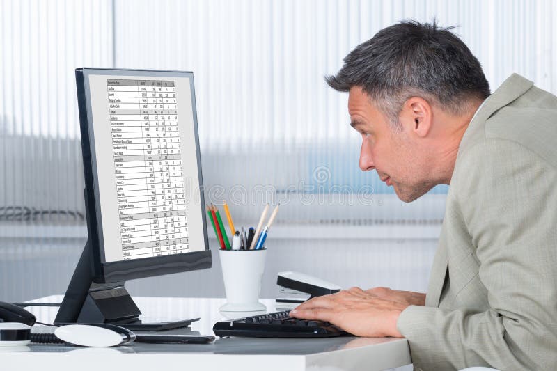 Concentrated Businessman Using Computer at Desk Stock Photo - Image of ...