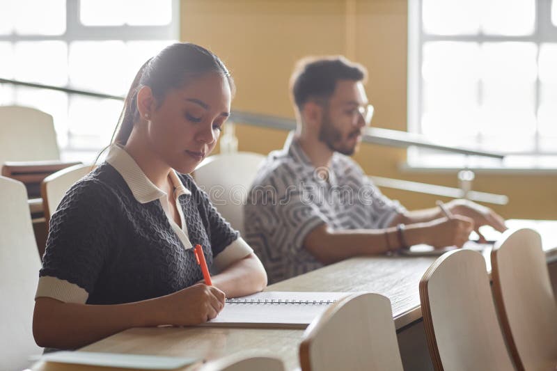 Focused Female College Student Writing Lecture in Classroom Stock Image ...
