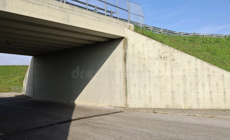 Side View of a Concrete Road Bridge, with Grass and Guard Rail in Entry ...