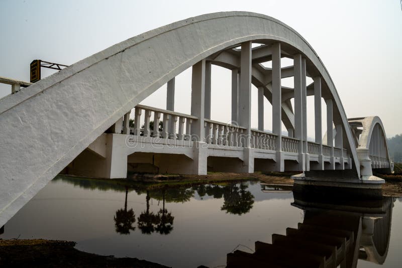 Side View of Concrete White Railroad Bridge with Reflection in the ...
