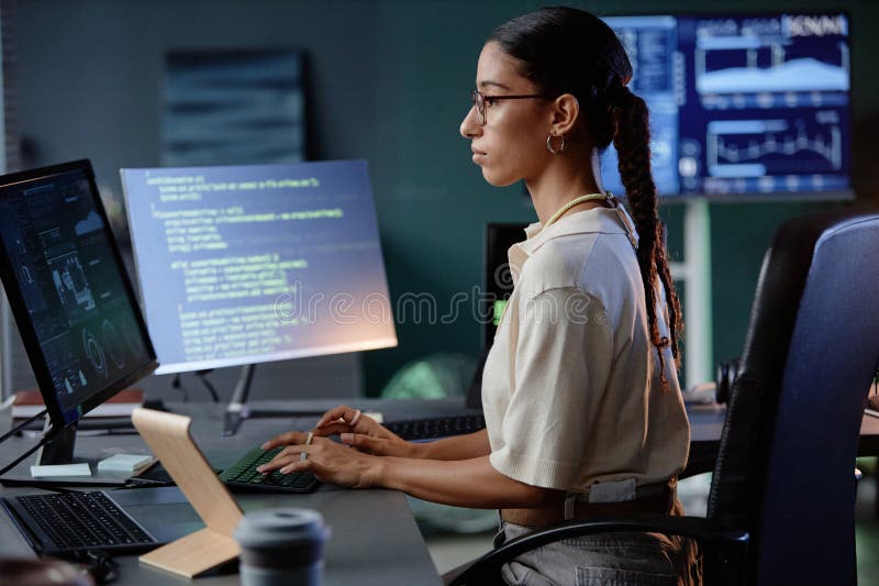 Middle Eastern Female Programmer Using Computer Writing Code at Workstation in Office Stock ...