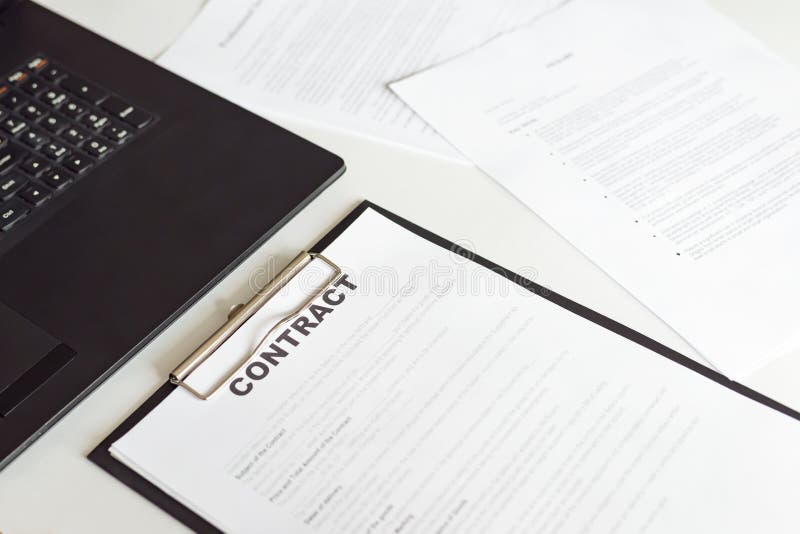 Side View of Contract in Clipboard Lying at Office on Table with Laptop ...