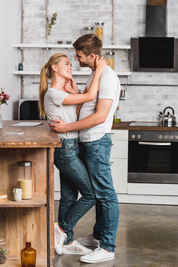 Side View of Couple Hugging in Kitchen and Leaning Stock Image - Image ...