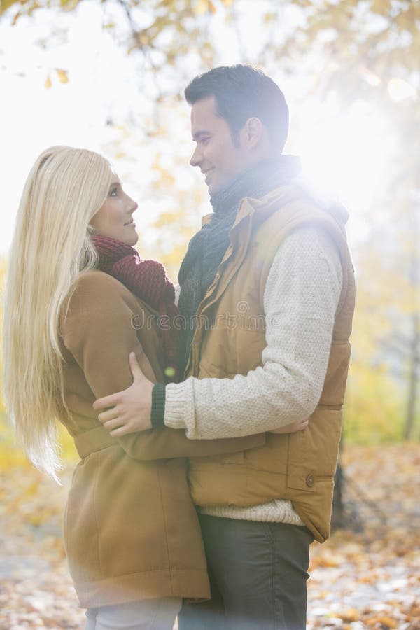 Side View of Couple Hugging in Park Stock Photo - Image of lifestyle ...