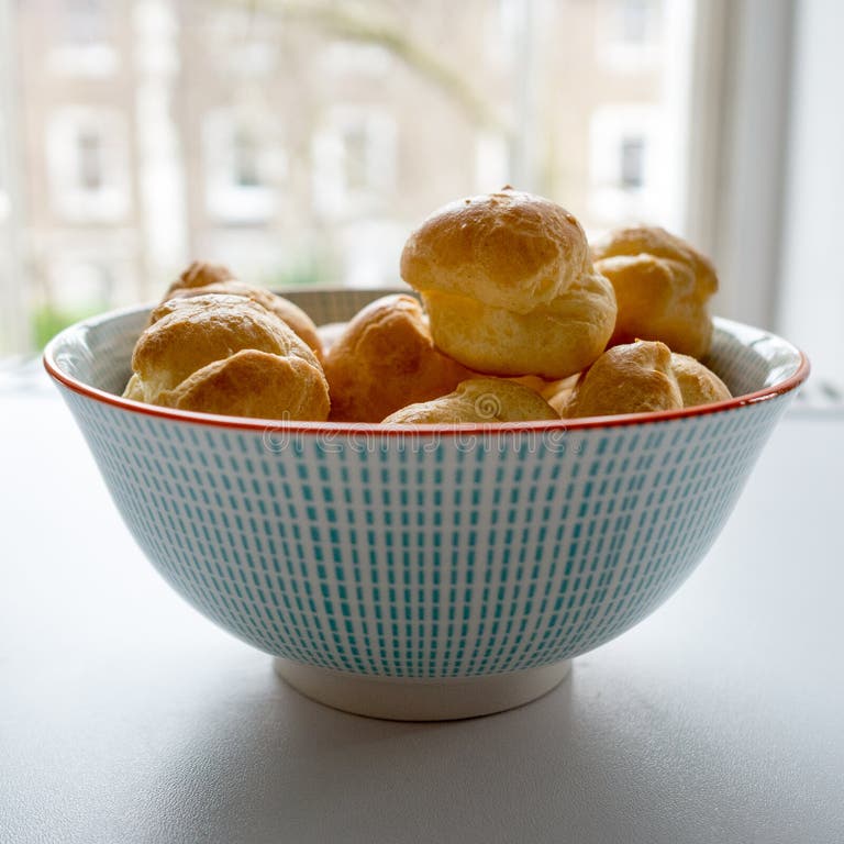Side View of Cream Puffs in a Blue Dotted Bowl on a White Table. Stock ...