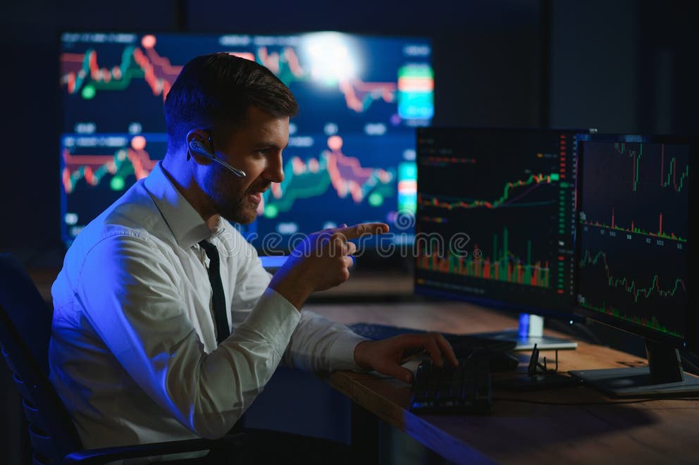 Side View of Crypto Broker Sitting at Office Table, Analyzing Market ...